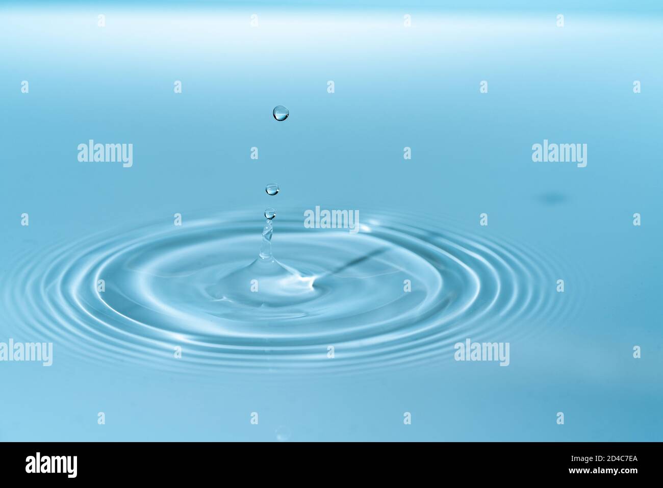 Waves on the surface of the water from a collision. Drop of water drop ...