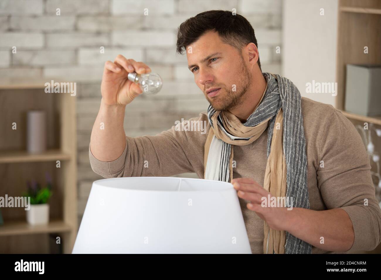 Men replacing lightbulb hi-res stock photography and images - Alamy