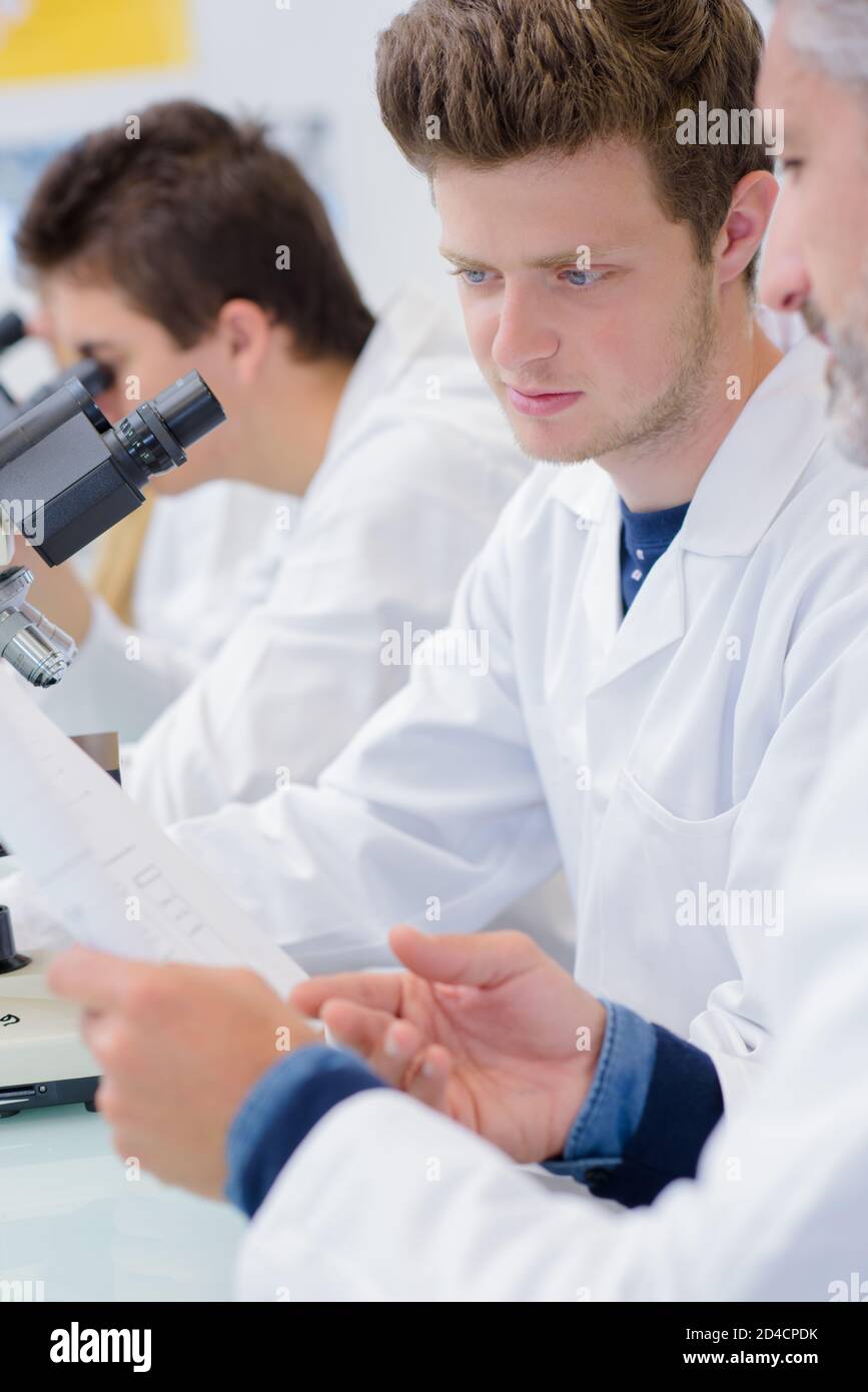 student and teacher in laboratory Stock Photo - Alamy