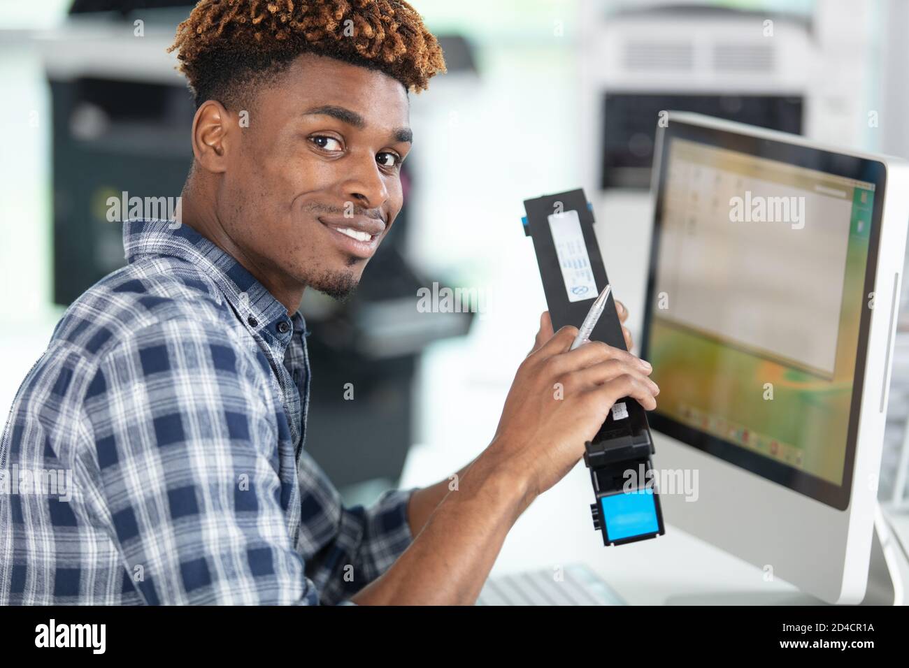 worker order new cartridge online on his computer Stock Photo - Alamy