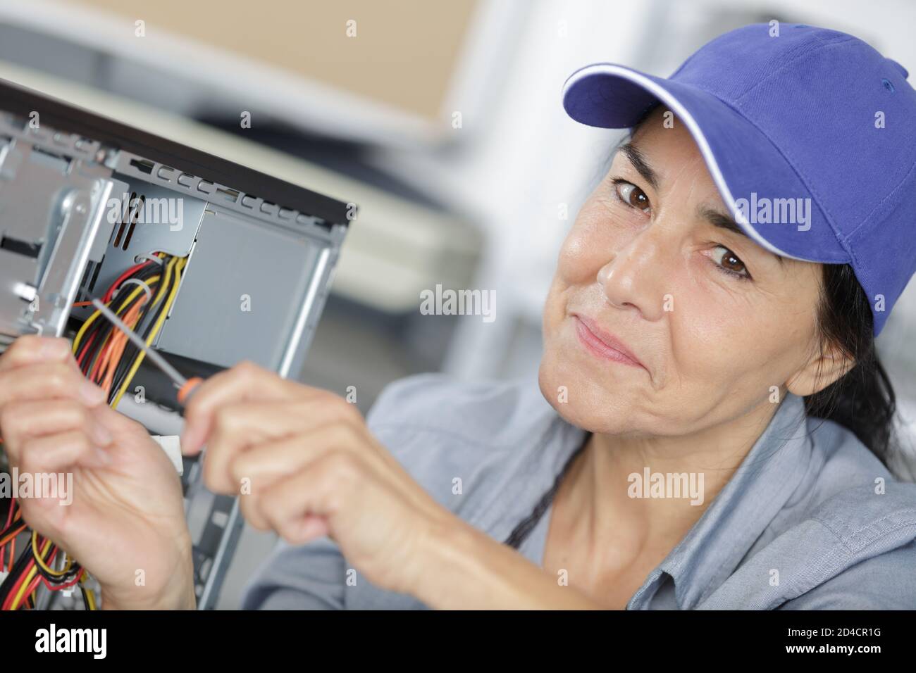 woman fixing a desktop computer Stock Photo - Alamy