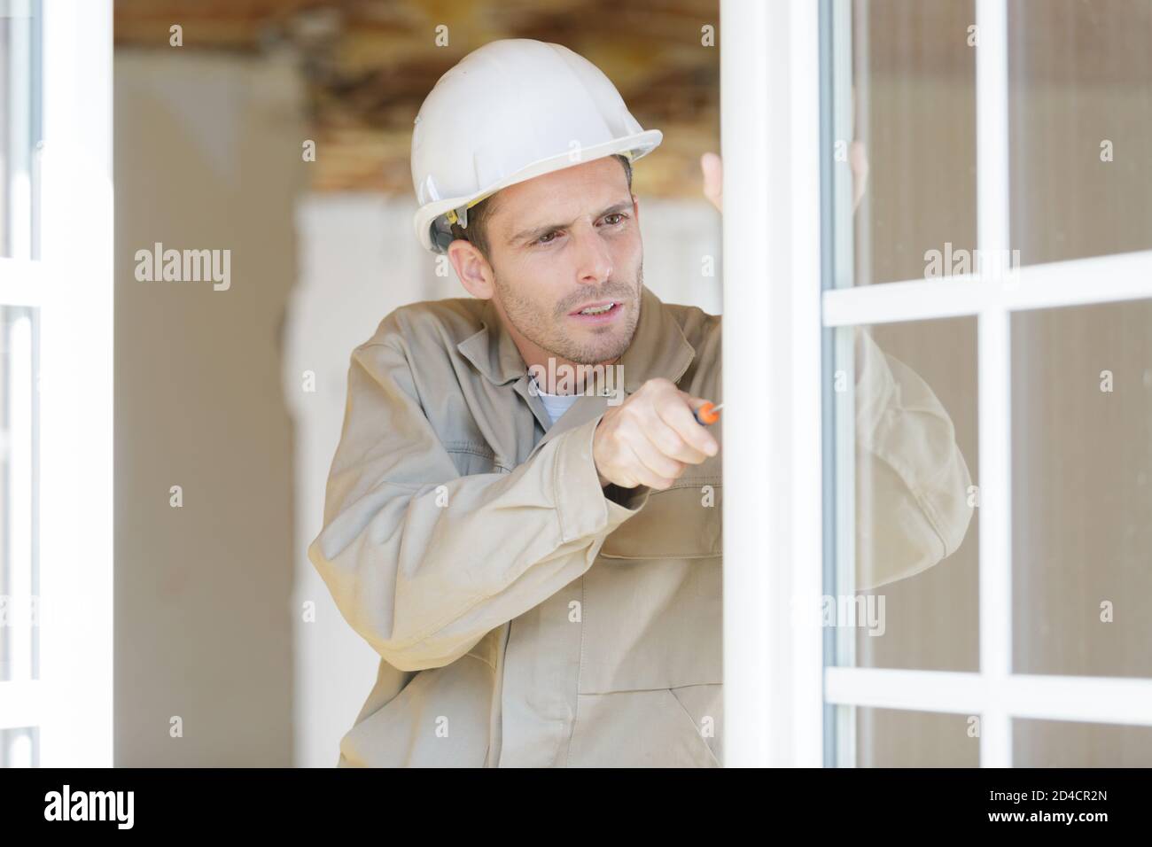 construction worker installing window in house Stock Photo - Alamy