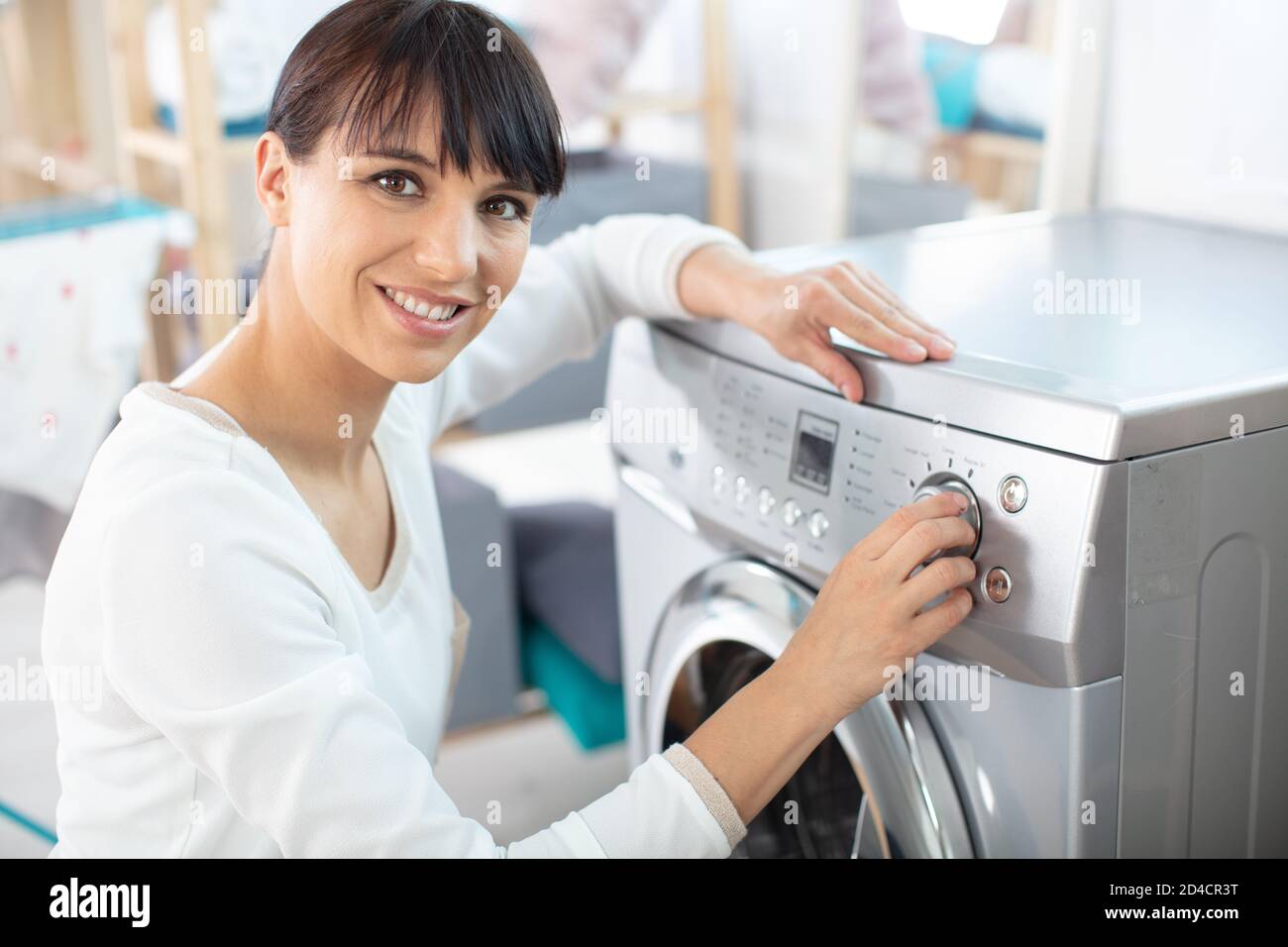 Woman setting washing machine hi-res stock photography and images - Alamy