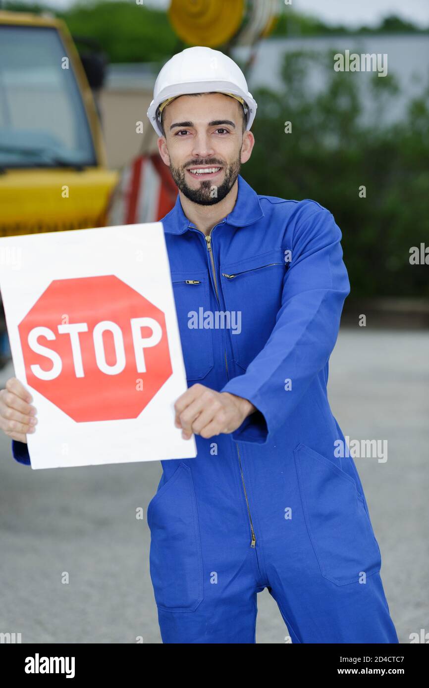 builder in helmet stop sign Stock Photo - Alamy
