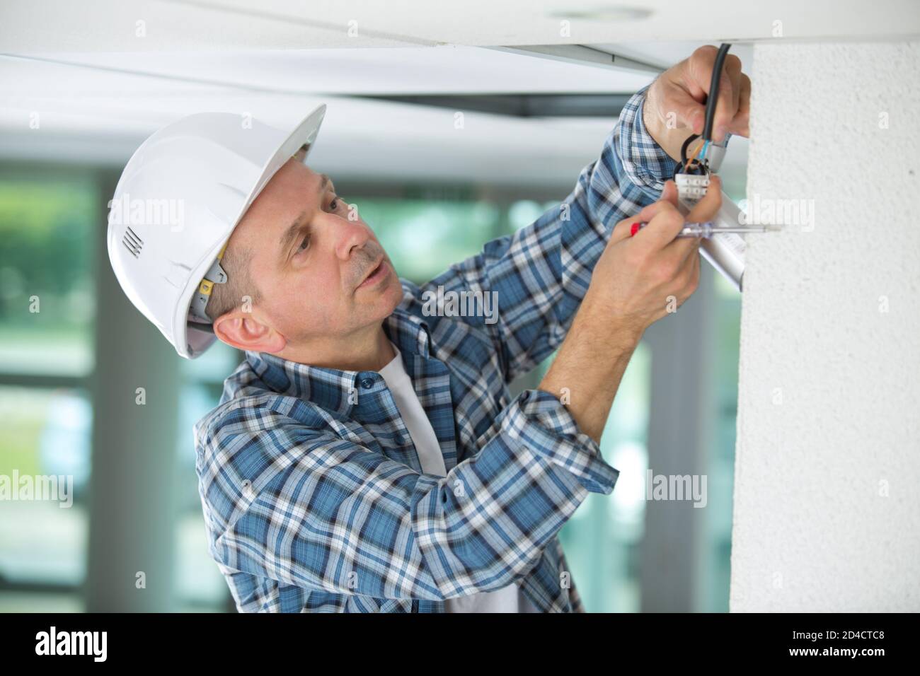 electrician working on indoor installation Stock Photo - Alamy