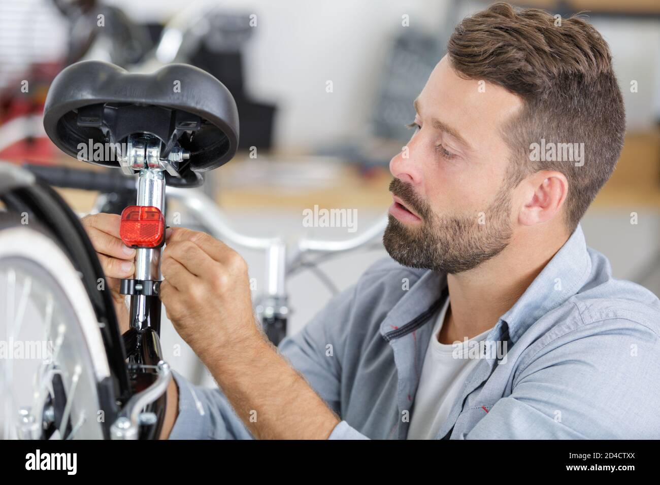 a man repairing a bike Stock Photo - Alamy