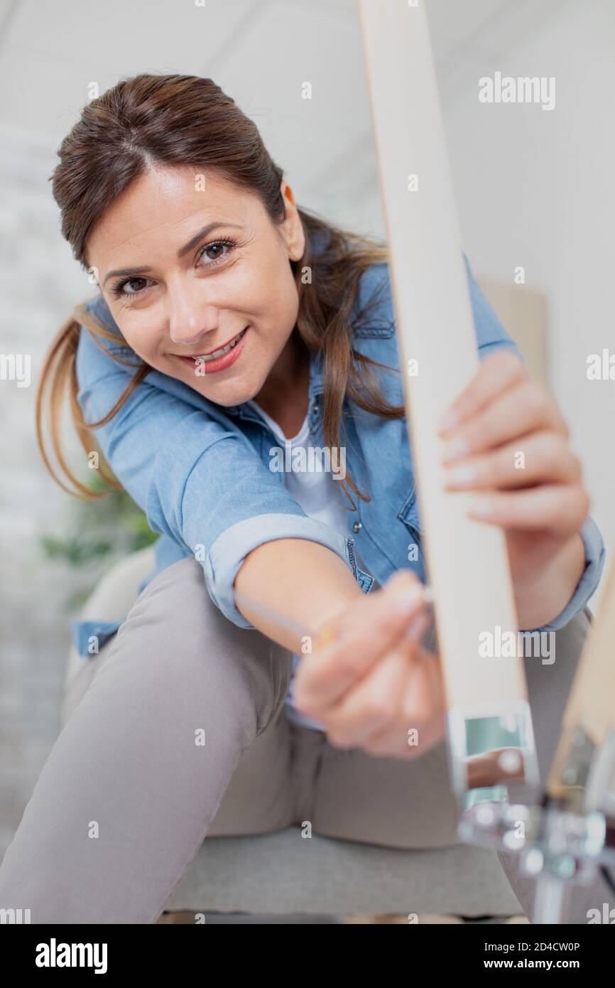 woman assembling a furniture using hex key Stock Photo - Alamy