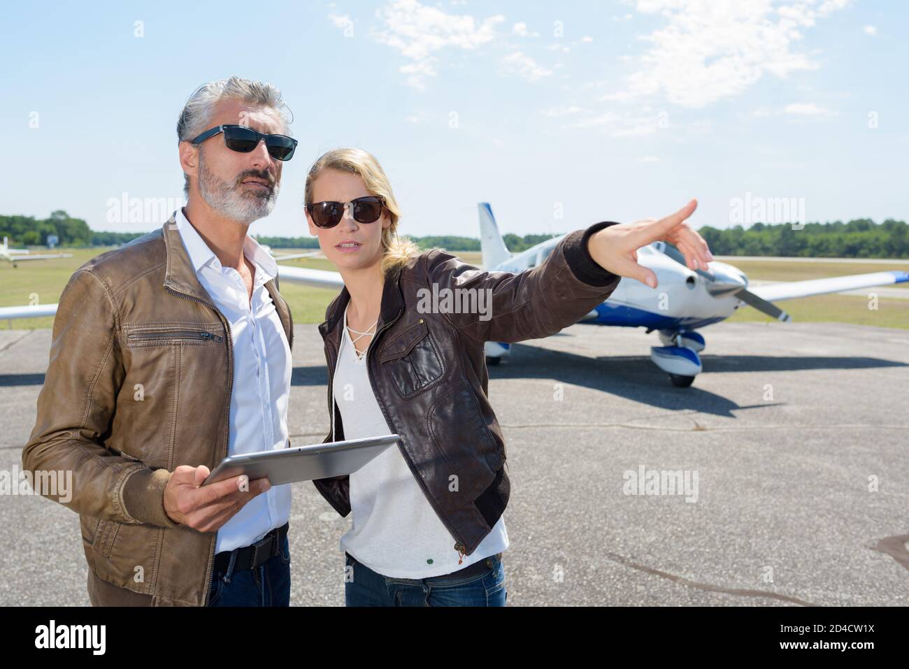 student pilot and instructor going through a pre-flight pilot checklist ...