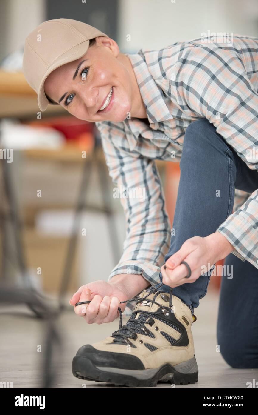female worker doing her laces up Stock Photo - Alamy