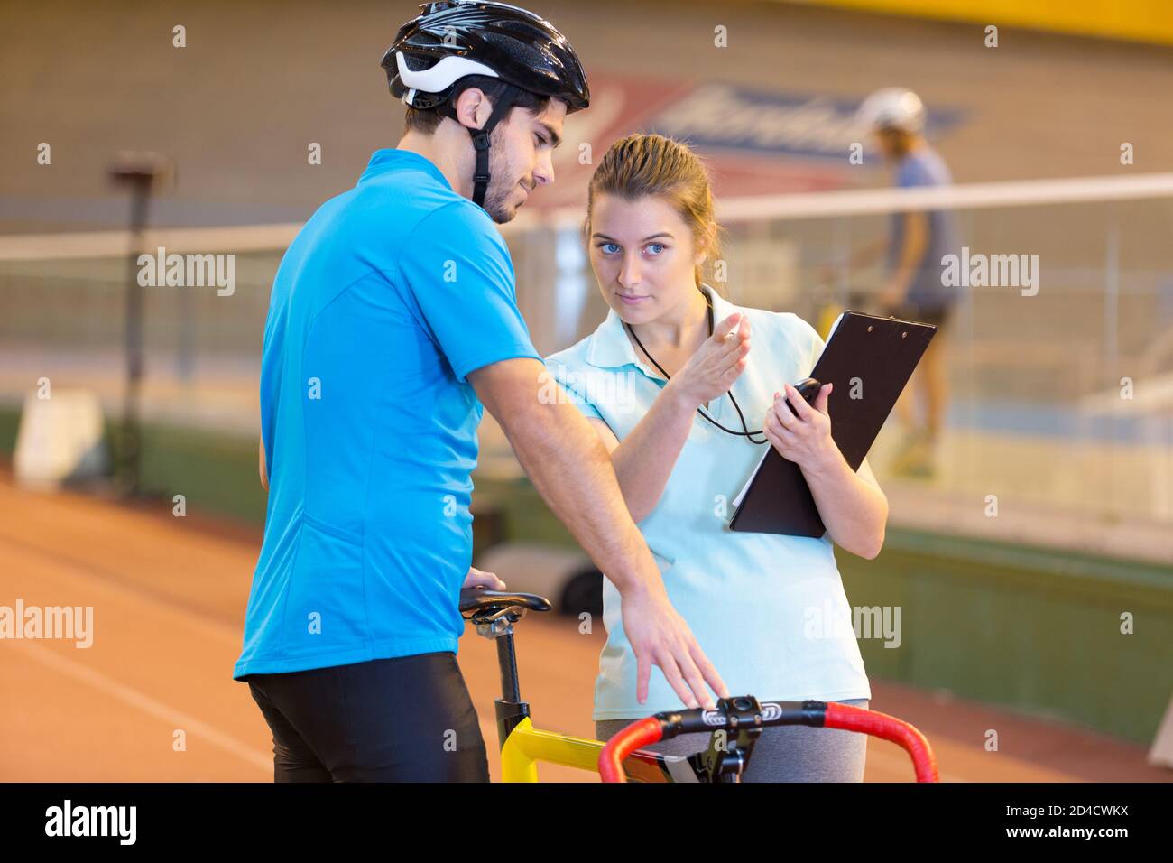 female coach with cyclist at a velodrom Stock Photo - Alamy