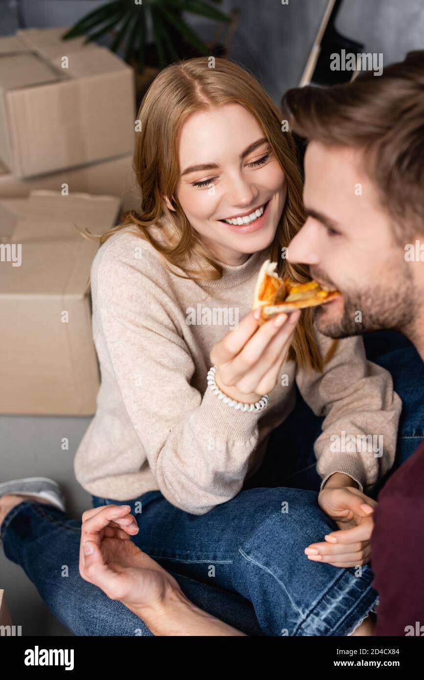 Young woman feeding man junk food hi-res stock photography and images ...
