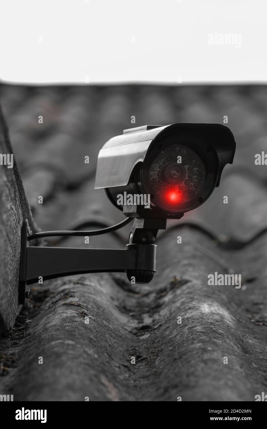 Home security concept. Black CCTV camera with glowing red bulb attached ...