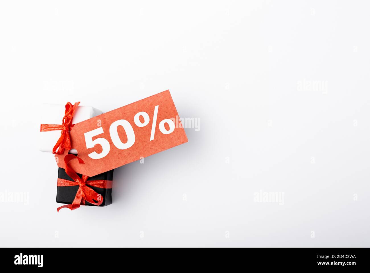 Top view of price tag with 50 and percent signs on toy gift boxes on ...