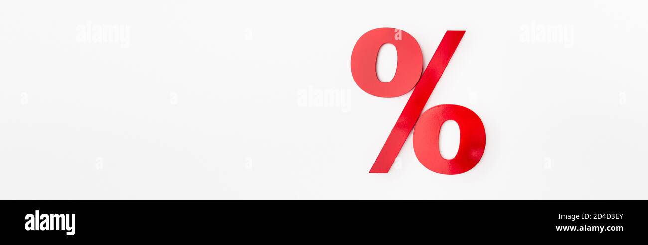 Panoramic shot of red percent sign on white background Stock Photo - Alamy