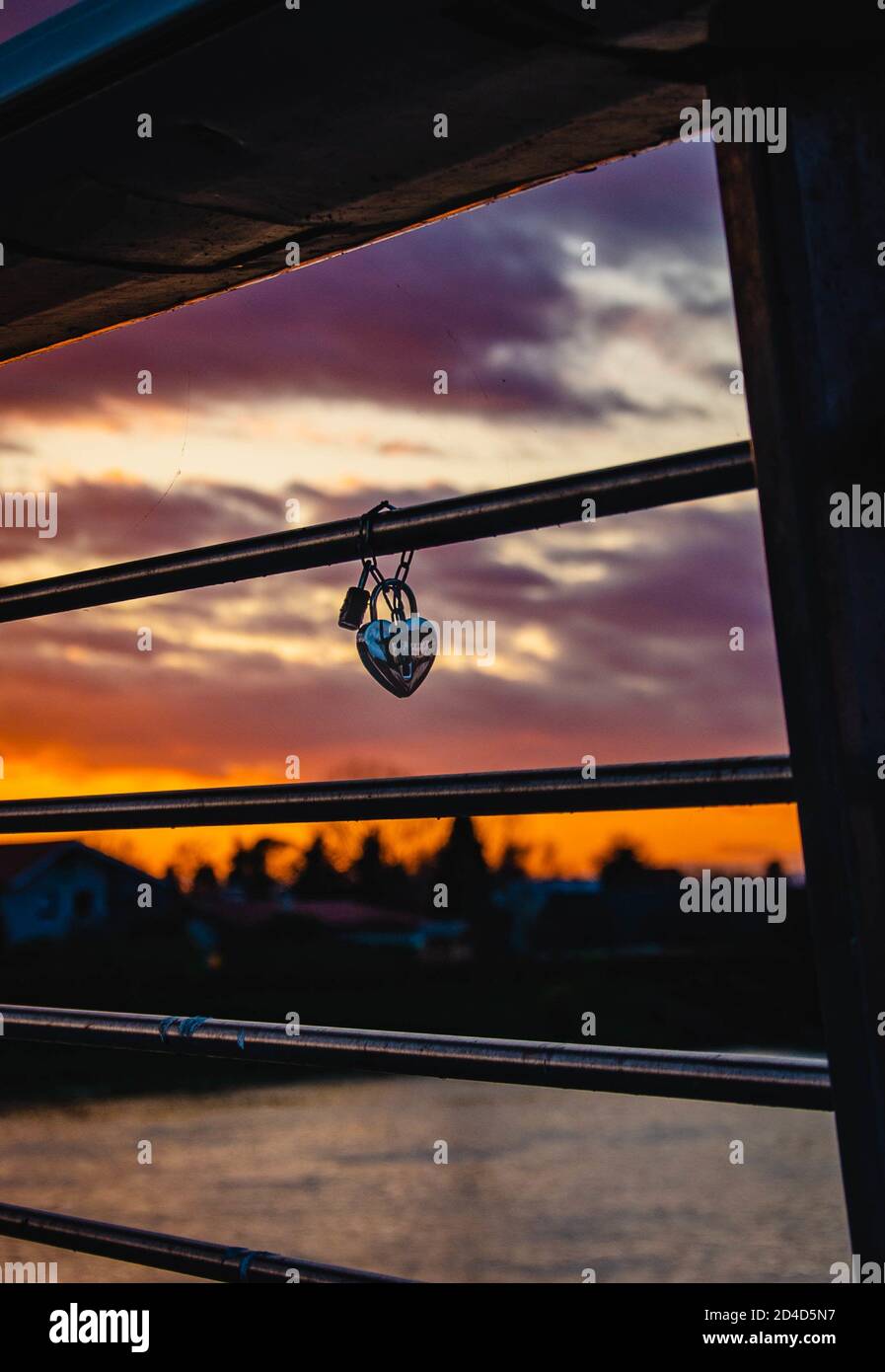 Closeup of a heart lock attached to the bridge Stock Photo - Alamy