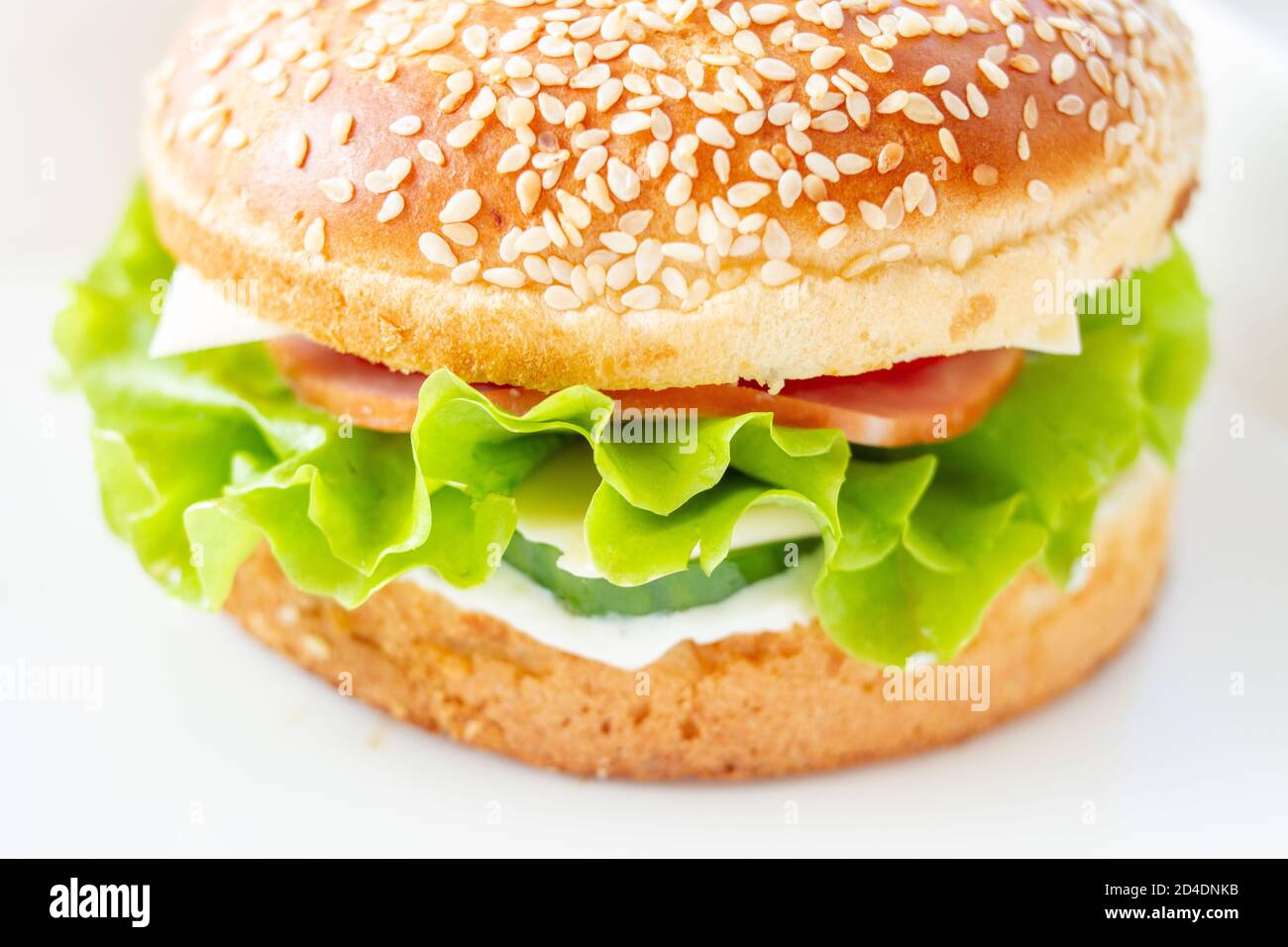 Burger with lettuce and sesame seed bun Stock Photo - Alamy
