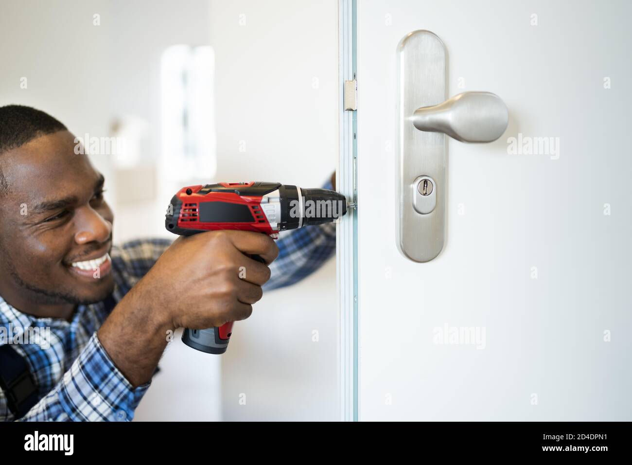 African Locksmith Man Changing And Fixing Door Lock Stock Photo - Alamy