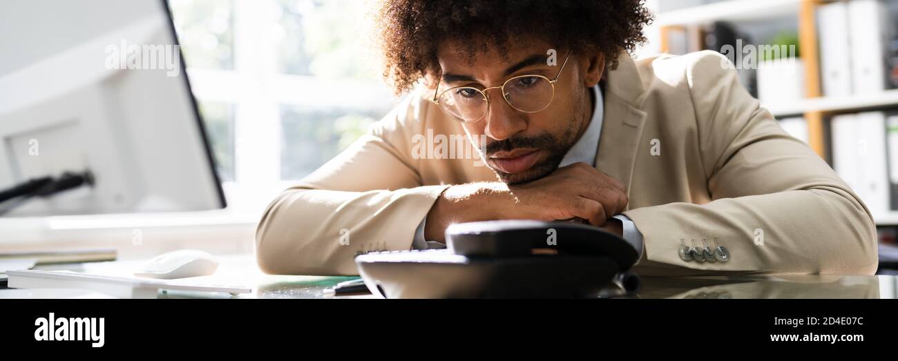 African American Waiting Landline Phone Call At Office Desk Stock Photo ...
