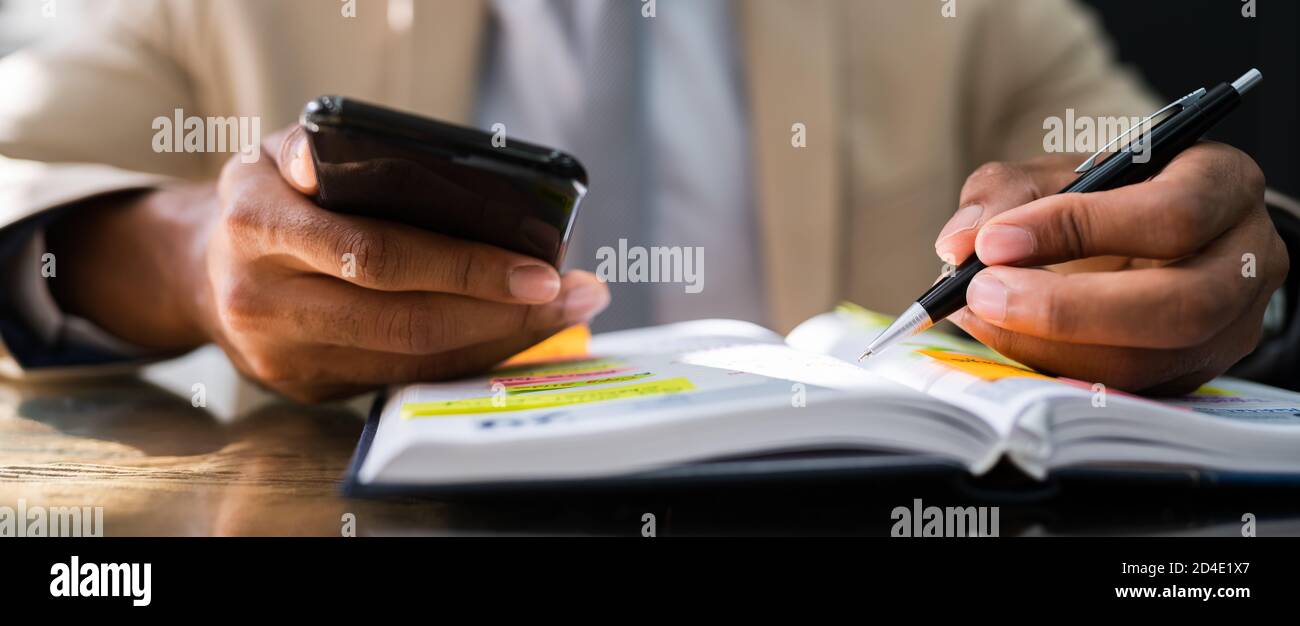 African Man Organizing Appointment Calendar Schedule Using Cellphone ...