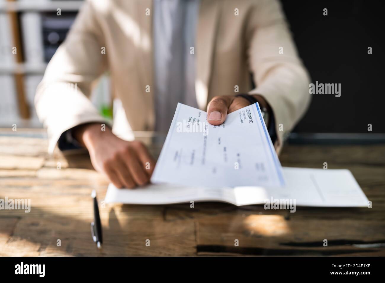 African Giving Cheque. Hand Holding Insurance Check Stock Photo - Alamy