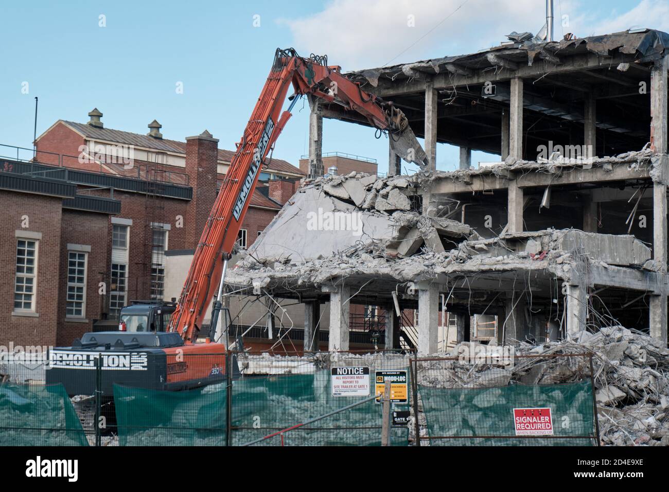 Construction crew with cranes working demolition of old building in ...