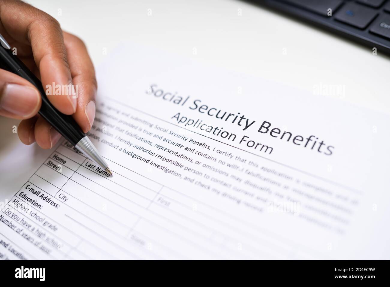 Close-up Of A Person's Hand Filling Social Security Benefits ...
