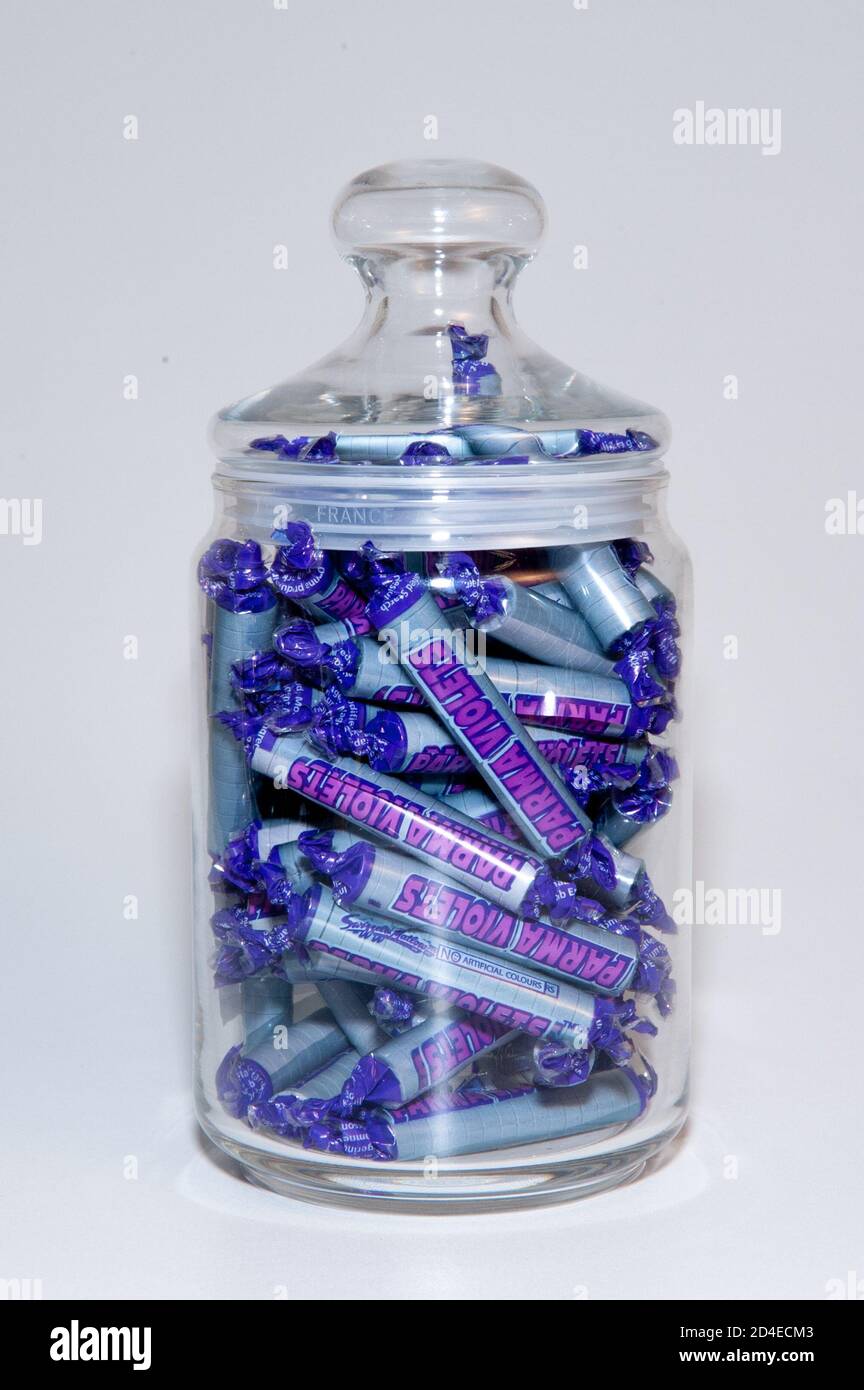 Packets of Parma Violets in a glass sweet jar Stock Photo - Alamy