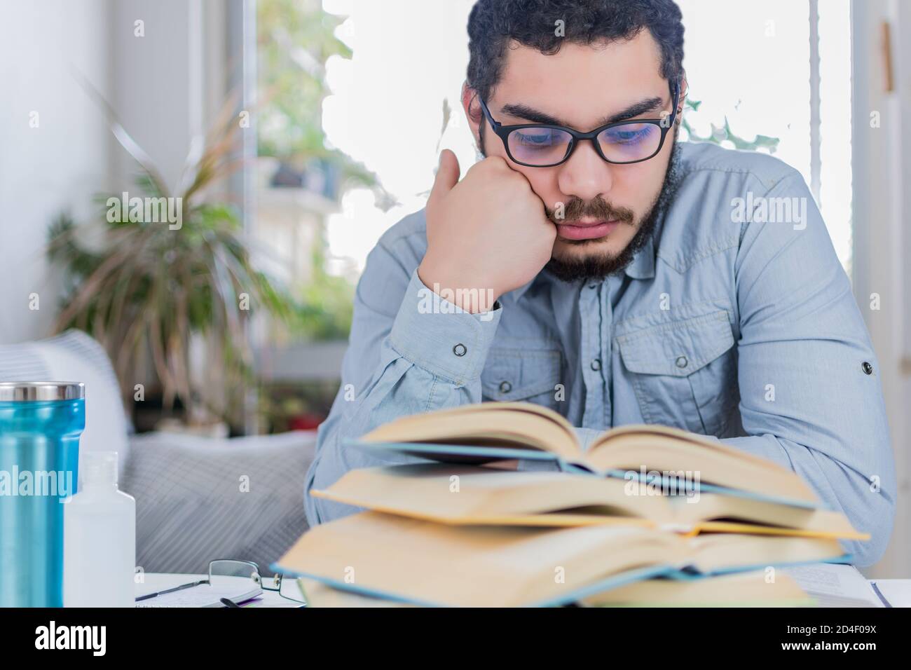 Concentrated student reading a textbook - Long-distance education Stock ...