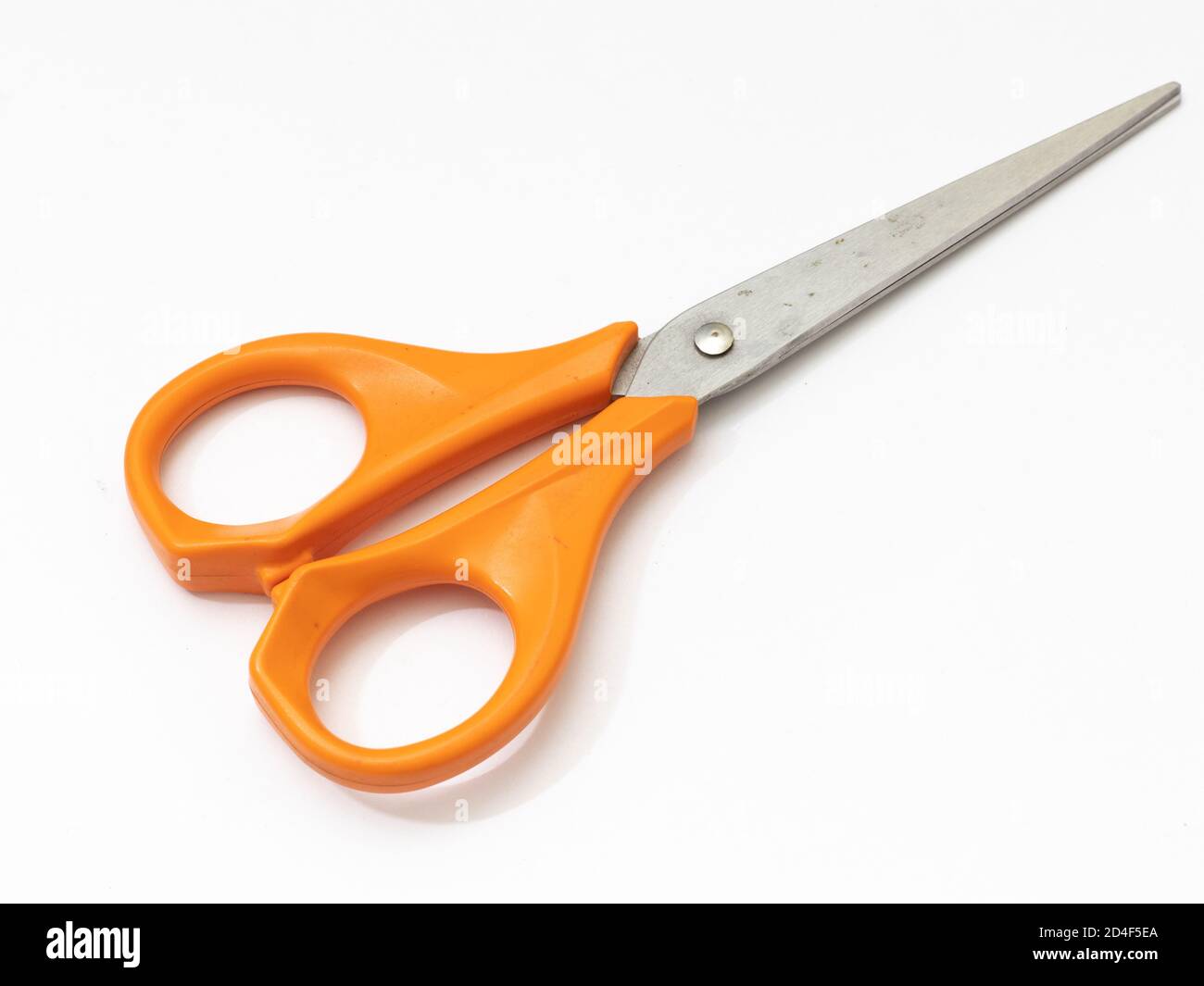 Orange scissor with white background Stock Photo - Alamy