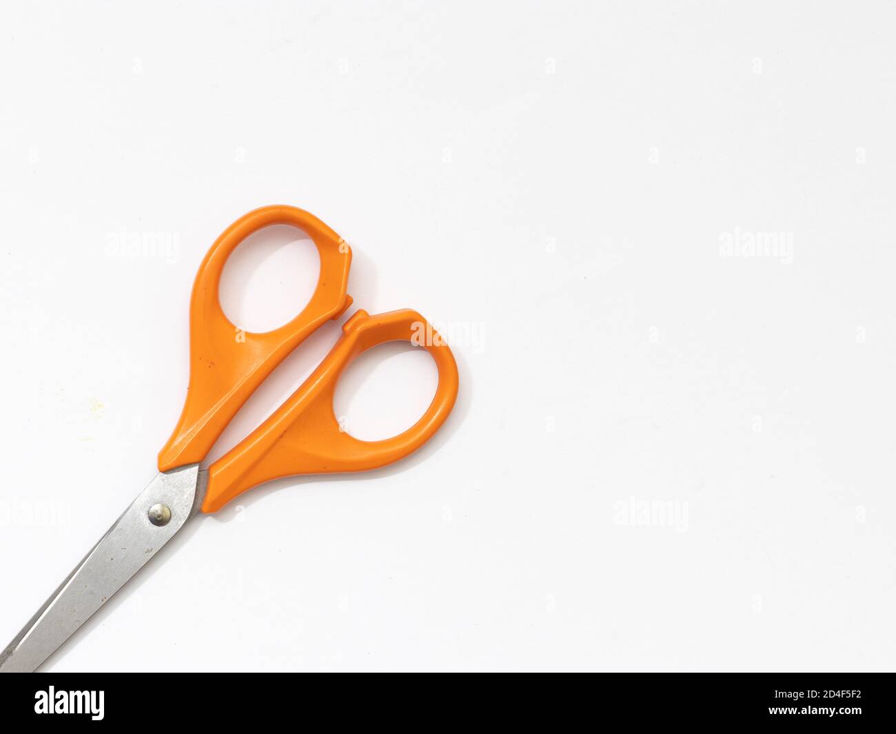 Orange scissor with white background Stock Photo - Alamy