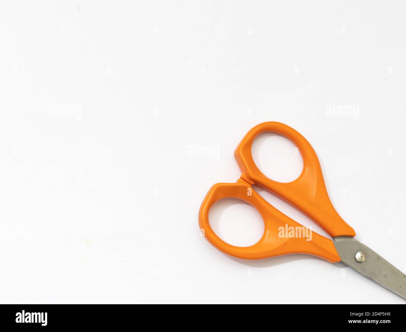 Orange scissor with white background Stock Photo - Alamy