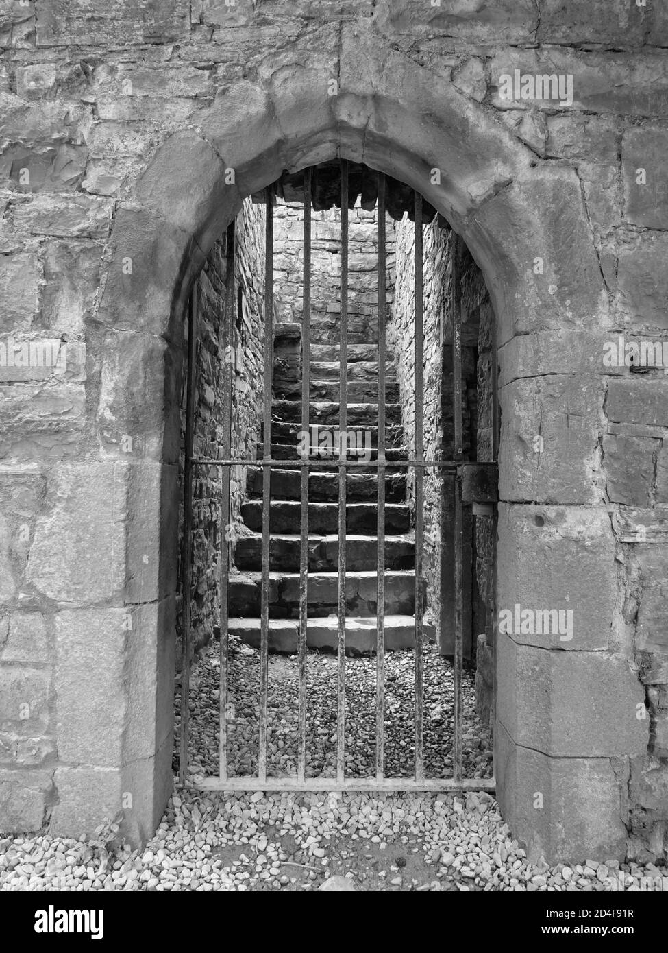 An iron gate in a stone walled ruin Stock Photo - Alamy