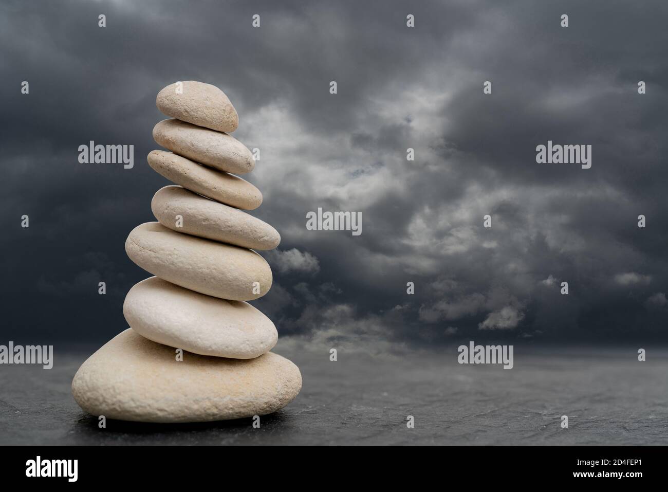 Stack of pebbles in an unstable state. A pyramid made of flat stones ...