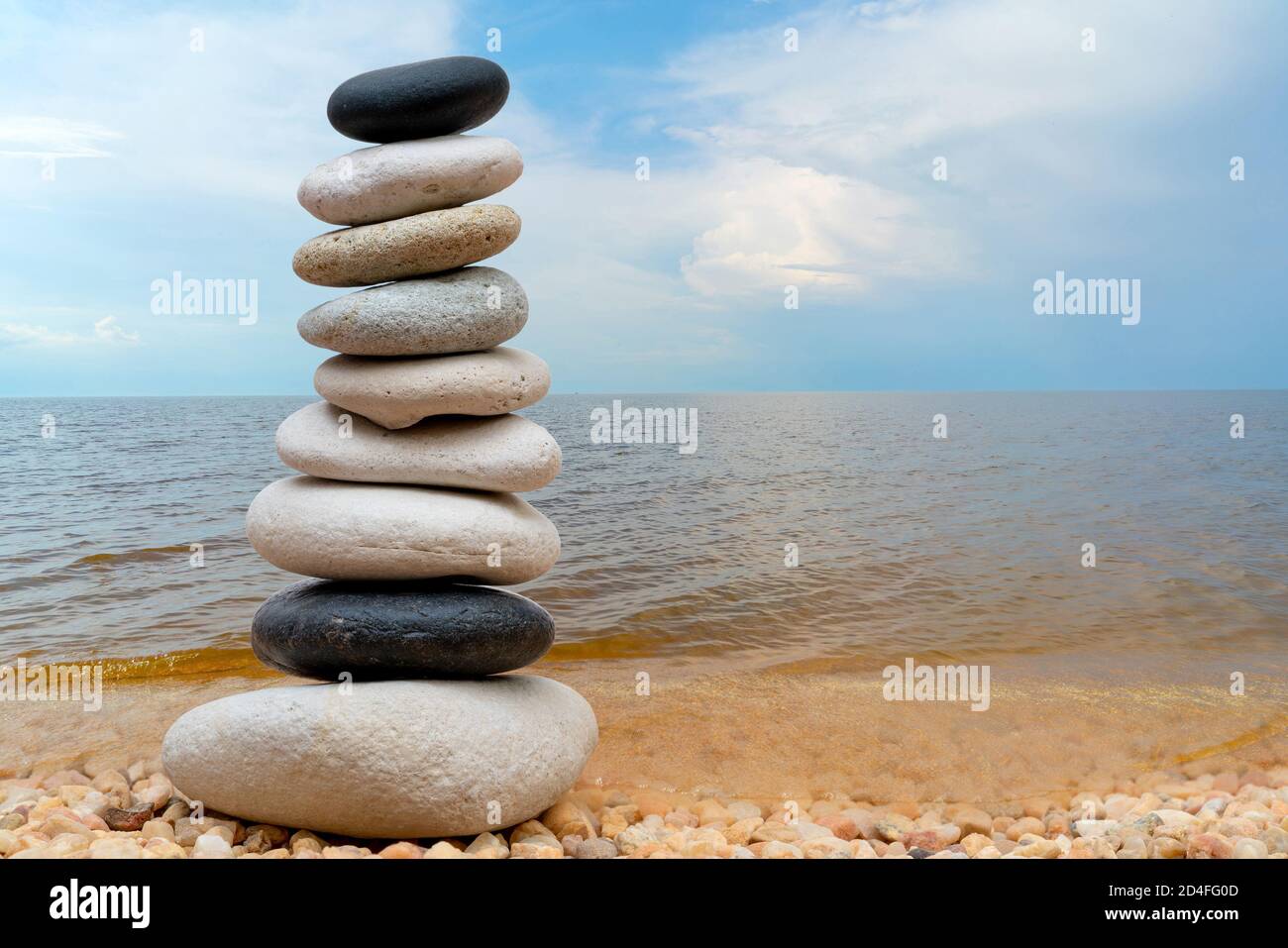 Stack of pebbles in an unstable state. A pyramid made of flat stones ...