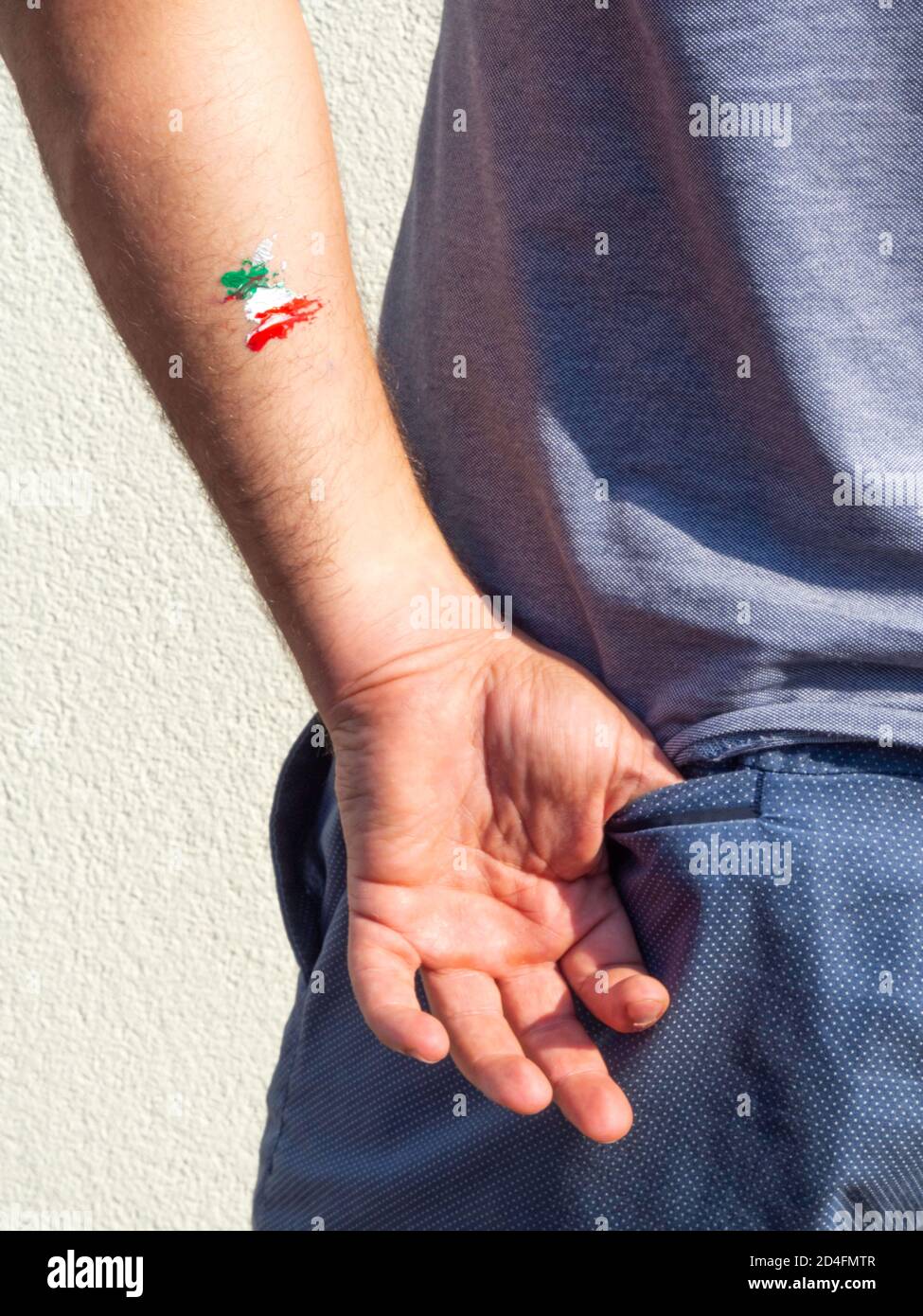 Painted flag tricolour green, white, red colors of Italy on strong man ...