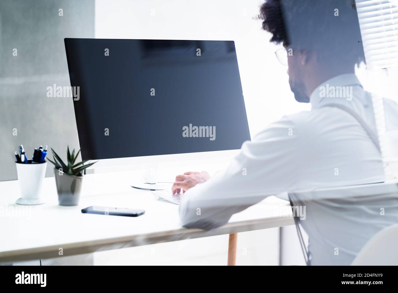 African American Working On Computer At Workplace Stock Photo - Alamy