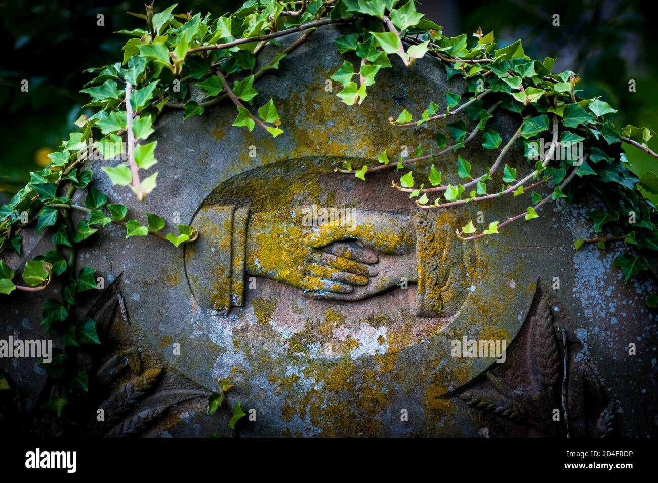Handshake of man and woman on an old gravestone Stock Photo - Alamy