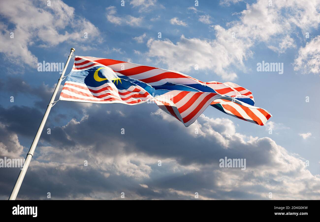Kuala Lumpur city flag waving in the wind against blue cloudy sky ...