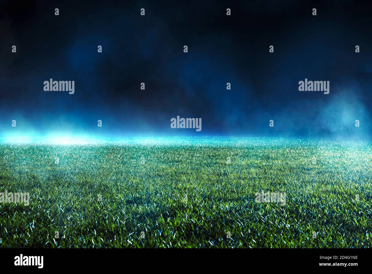 Night low view of maintained lawn at football stadium. Beams of light ...
