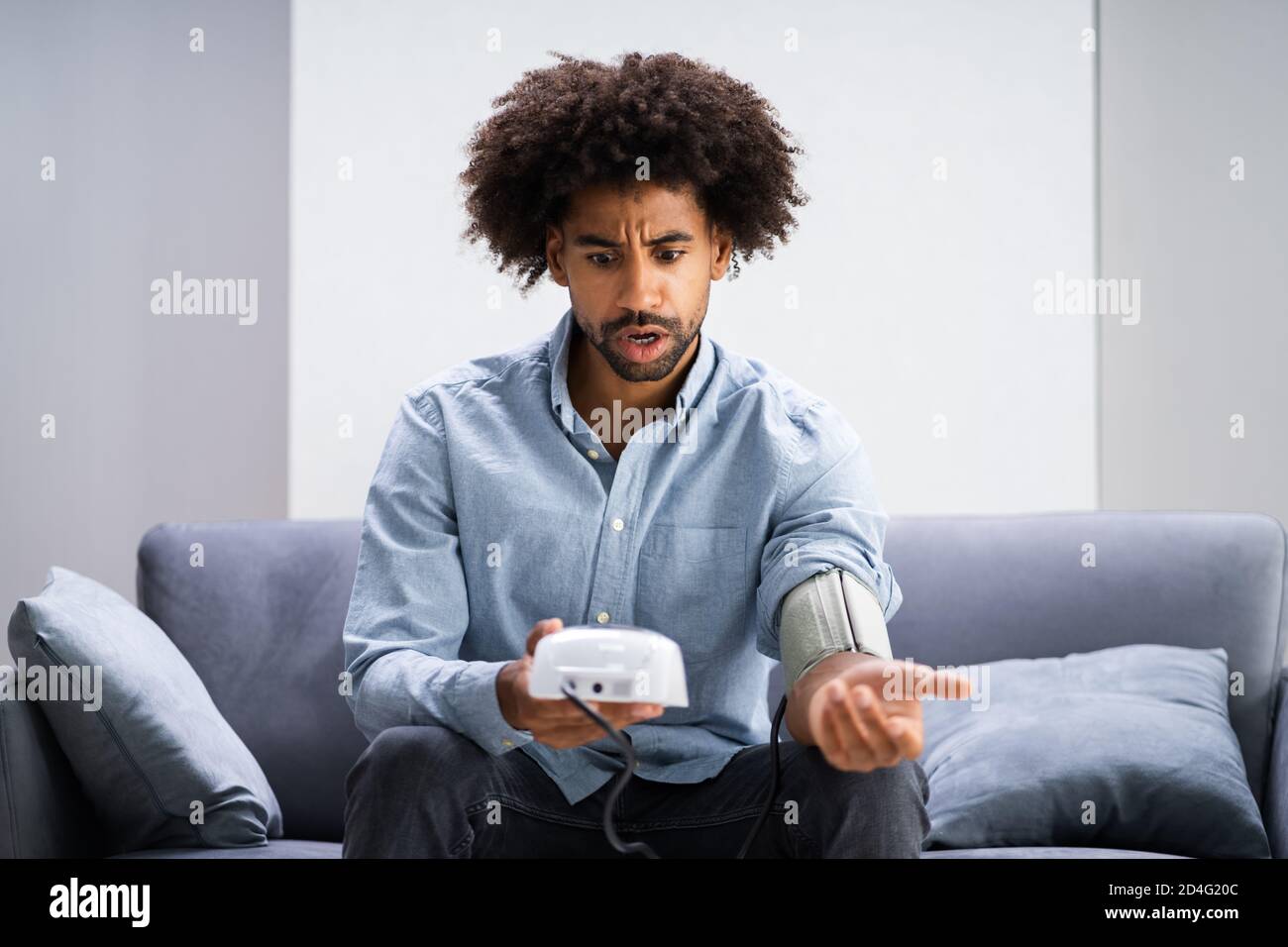 African Patient Doing Blood Pressure Check At Home Stock Photo - Alamy