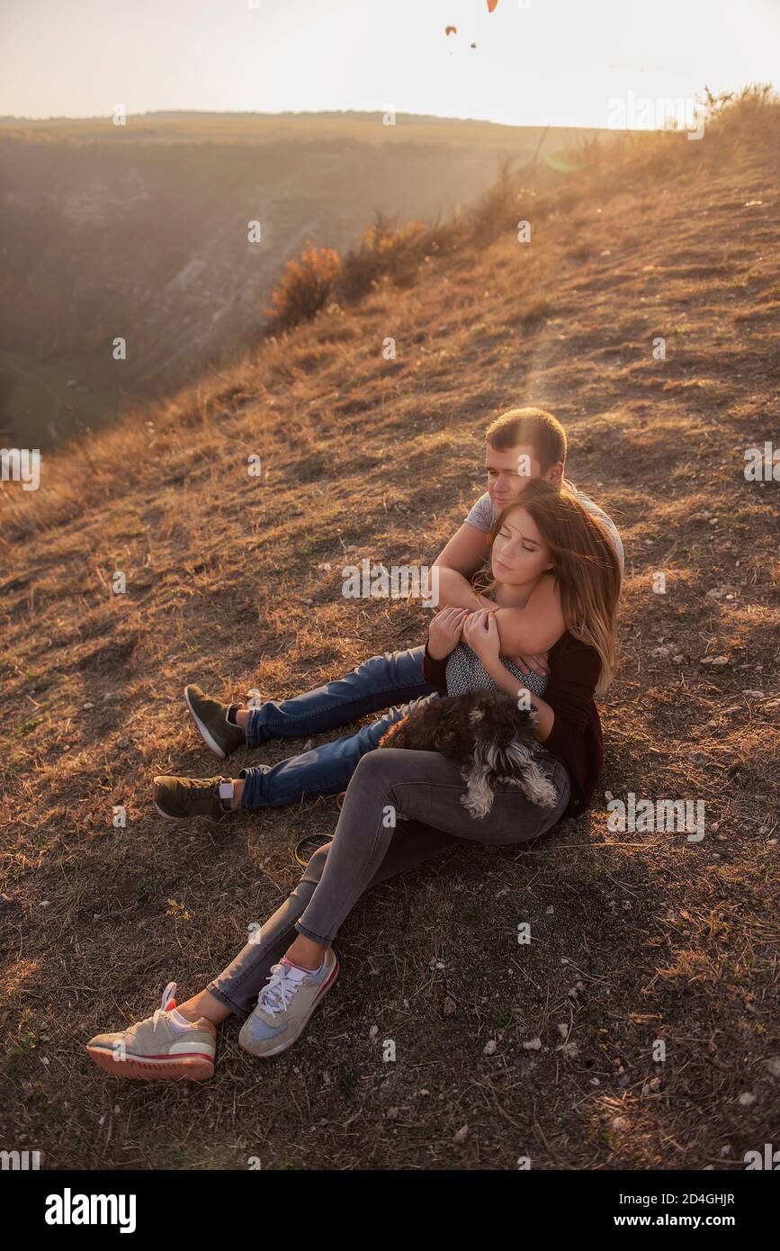 Trip with pets. Young family with a schnauzer dog travel. Beautiful ...