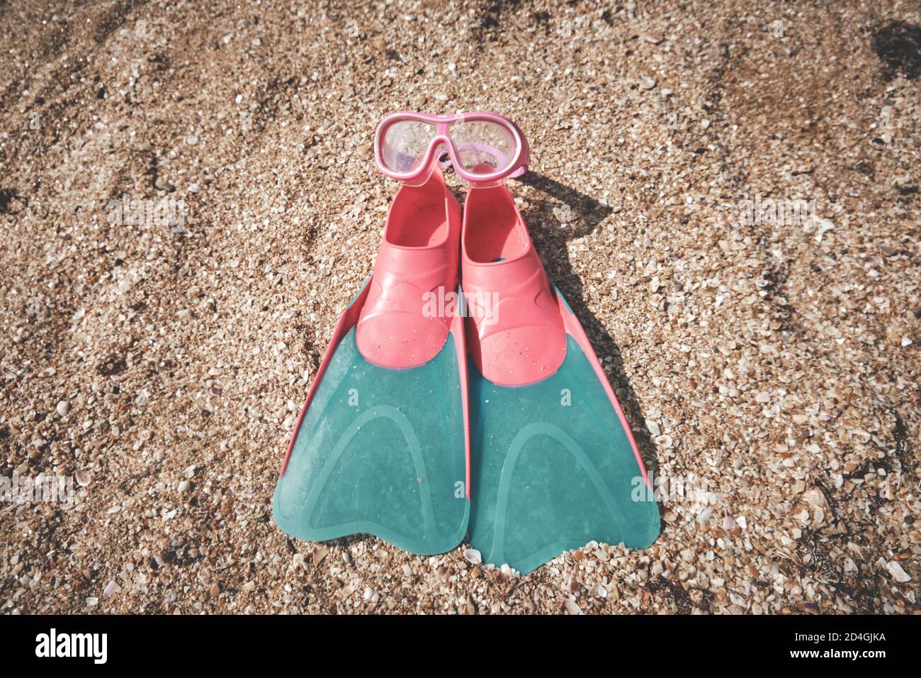 A snorkeling mask and baby flippers on the beach sand. High quality ...