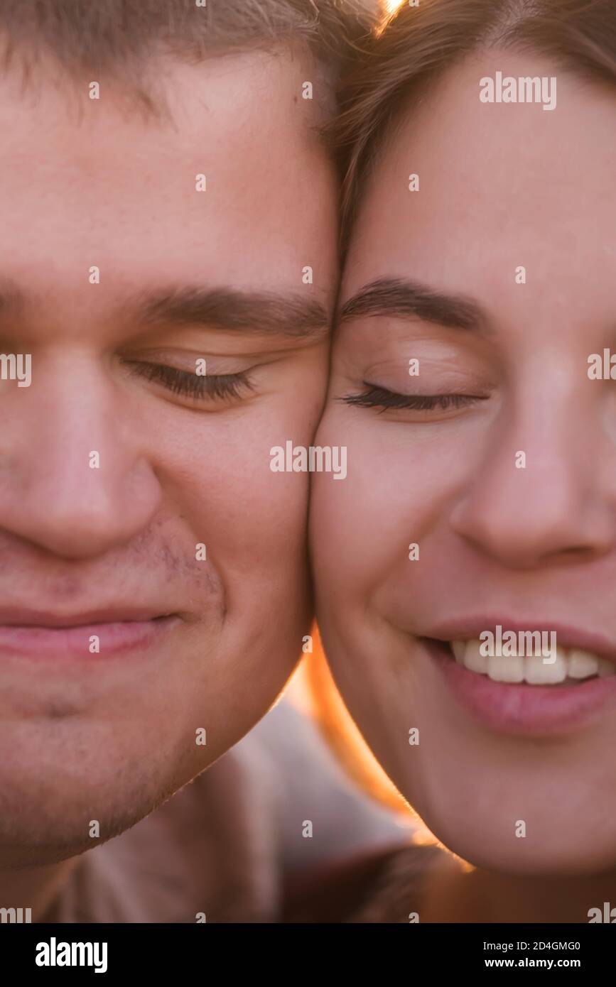 A very close-up portrait of couple in love, a young man pressed his ...