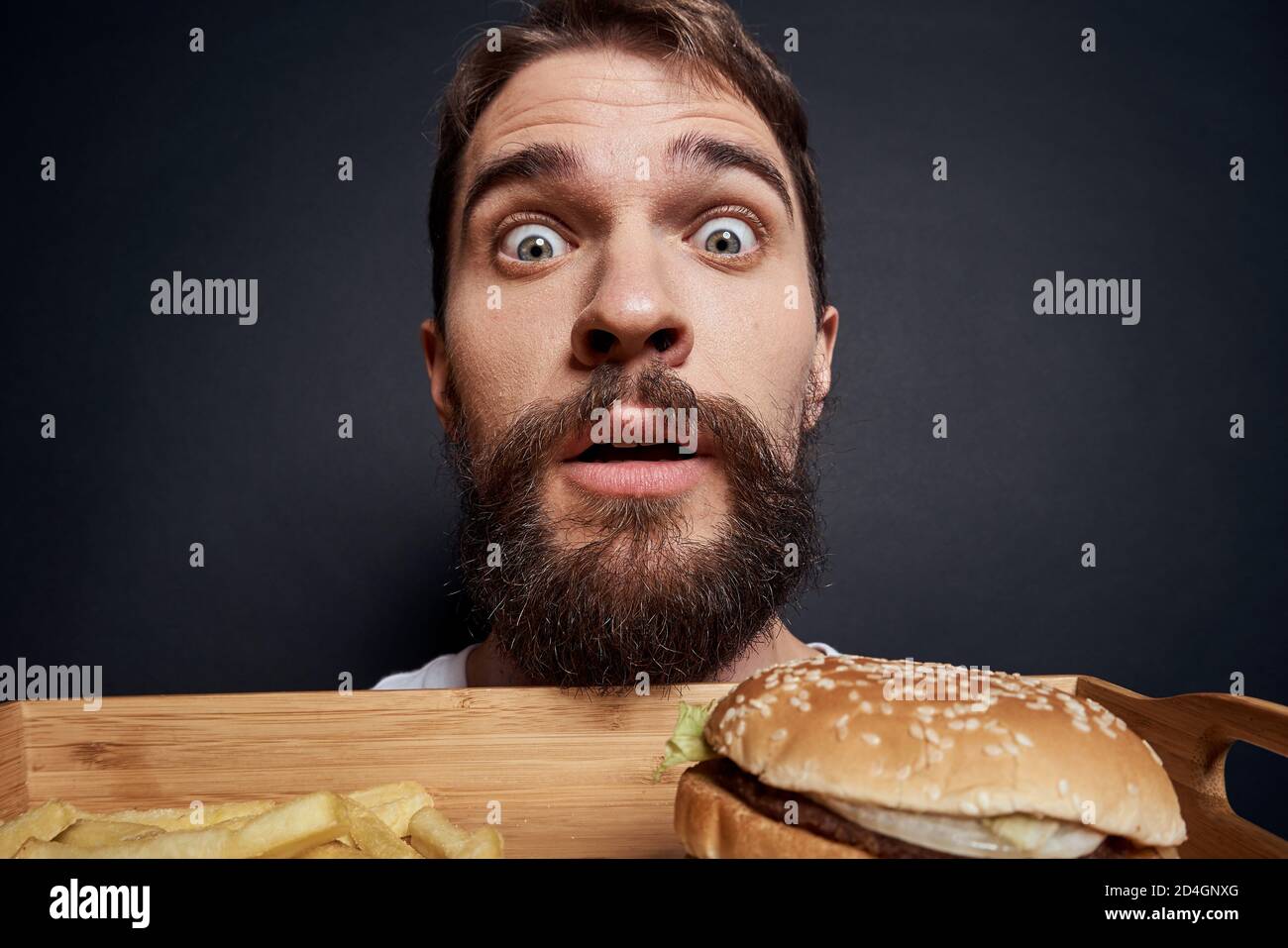 emotional man with wooden pallet fast food hamburger french fries ...