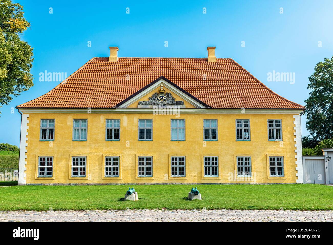 Facade of the The Commander House with two old cannons in Kastellet ...