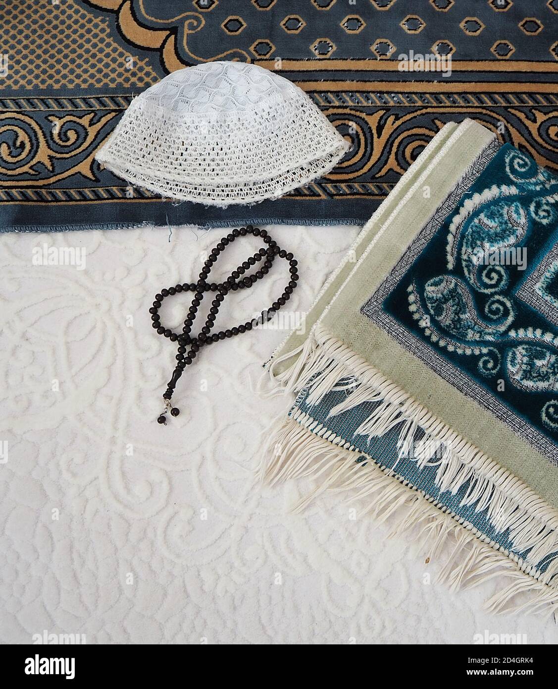 Worship tools and materials, prayer rug, rosary and skullcap in islam ...