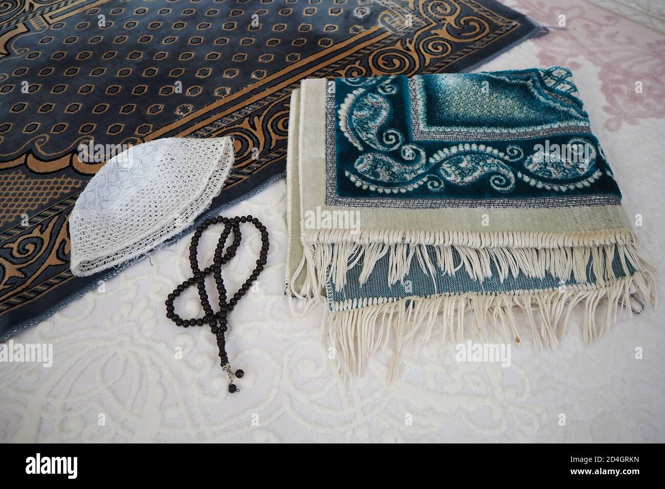 Worship tools and materials, prayer rug, rosary and skullcap in islam ...