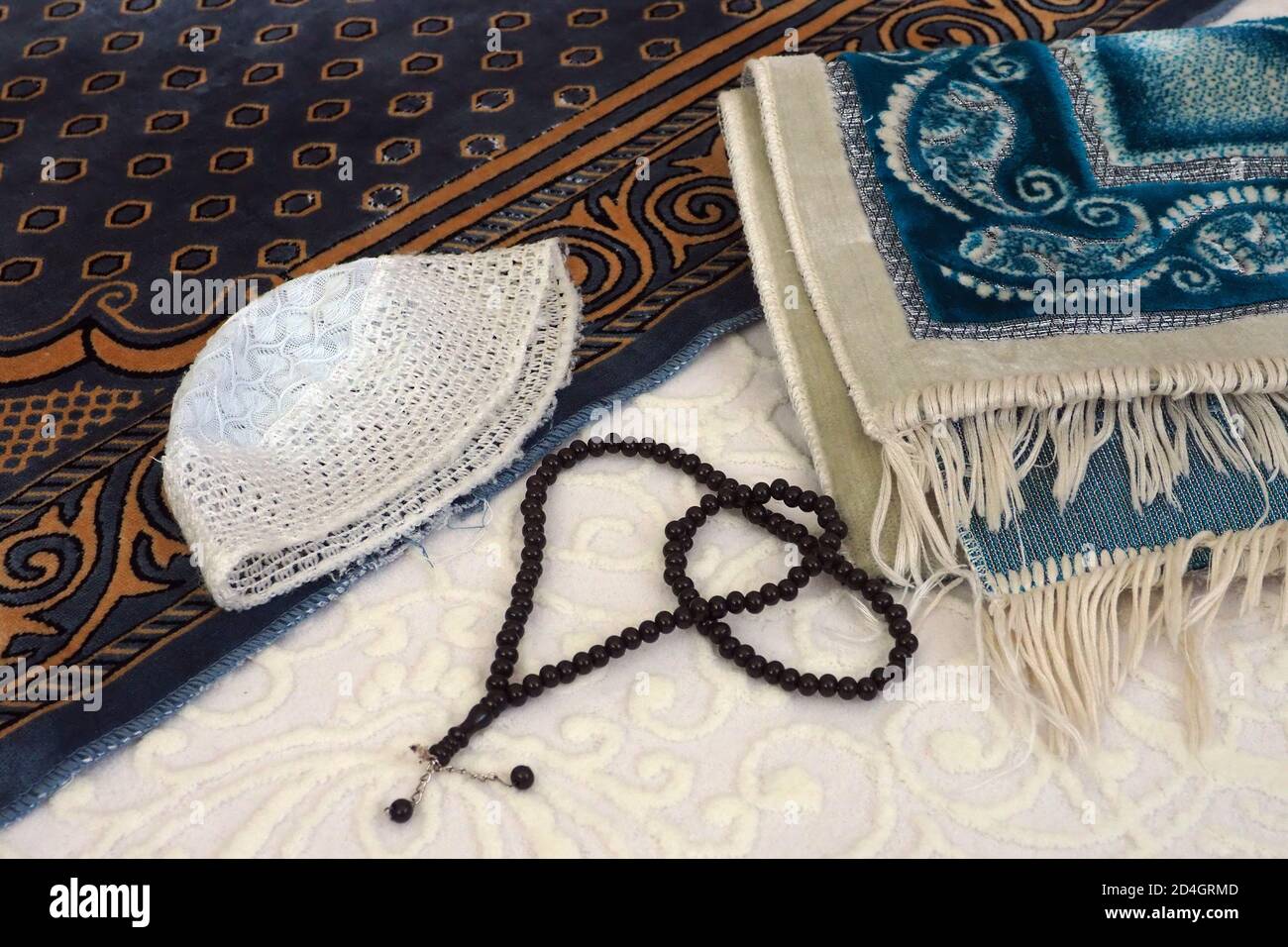 Worship tools and materials, prayer rug, rosary and skullcap in islam ...