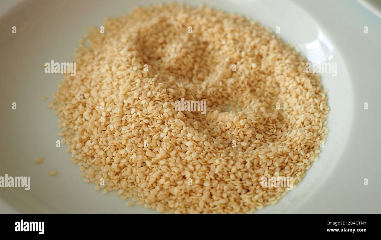 raw sesame to be put on close-up bagels, lots of dried sesame on the ...