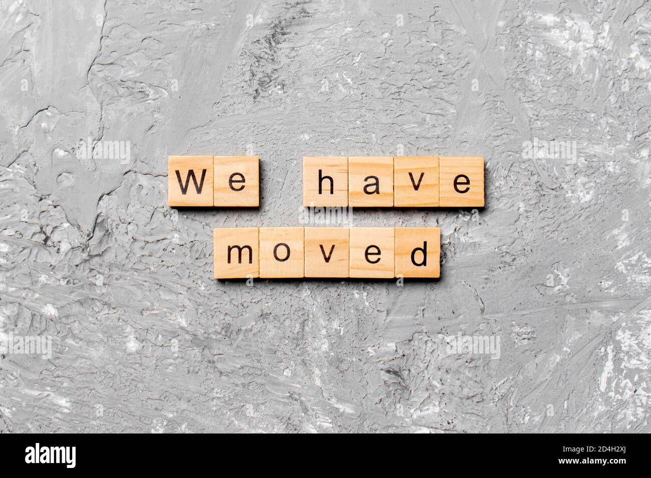 we have moved word written on wood block. we have moved text on cement ...